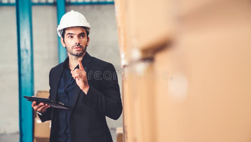 Factory Manager Using Tablet Computer in Warehouse or Factory Stock ...