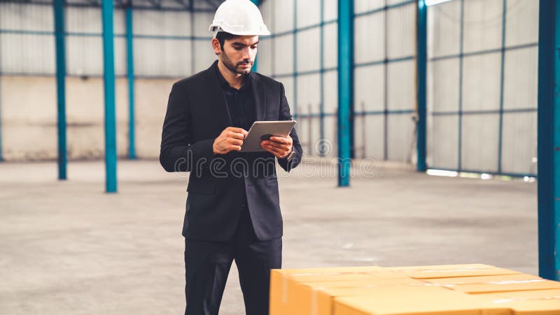 Factory Manager Using Tablet Computer in Warehouse or Factory Stock ...