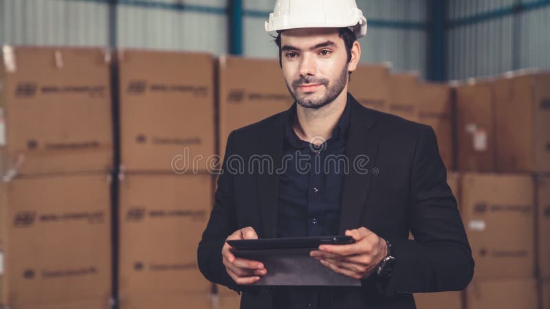 Factory Manager Using Tablet Computer in Warehouse or Factory Stock ...