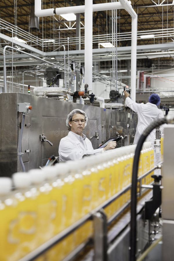 Two Men Working in Bottling Factory Stock Image - Image of commodity ...