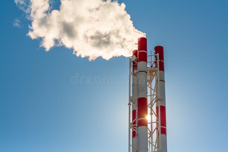 Factory Metallic Chimney with White Steam or Smoke Against a Blue Sky ...