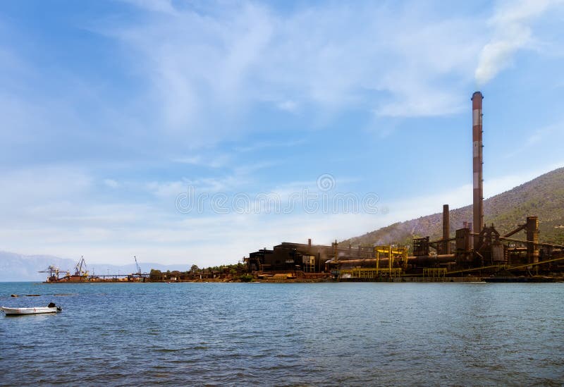 Factory at the blue sea stock photo. Image of business - 146224920