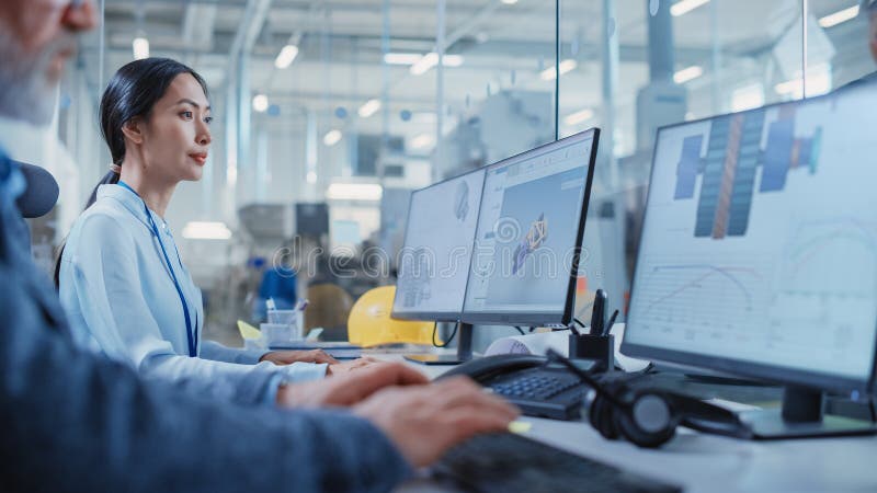 Factory Office Facility: Industrial Engineer Drafting Blueprints of a Heavy Industry Machine ...