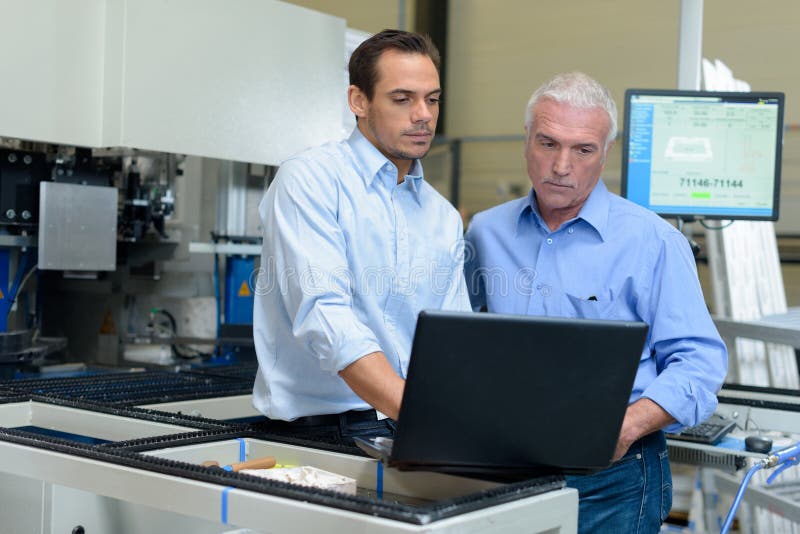 Factory Professionals Inspecting Design in Laptop Stock Image - Image ...