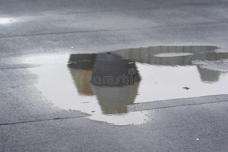 Puddle on the Roofing Material. Part of the Exhaust System is Visible ...