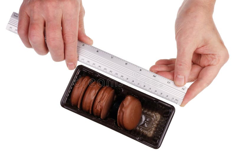 A Factory Technologist Checks the Size of Chocolate Donuts in a Plastic ...