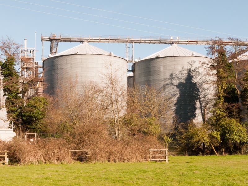 Factory Towers Seen from a Field in Spring Stock Photo - Image of ...