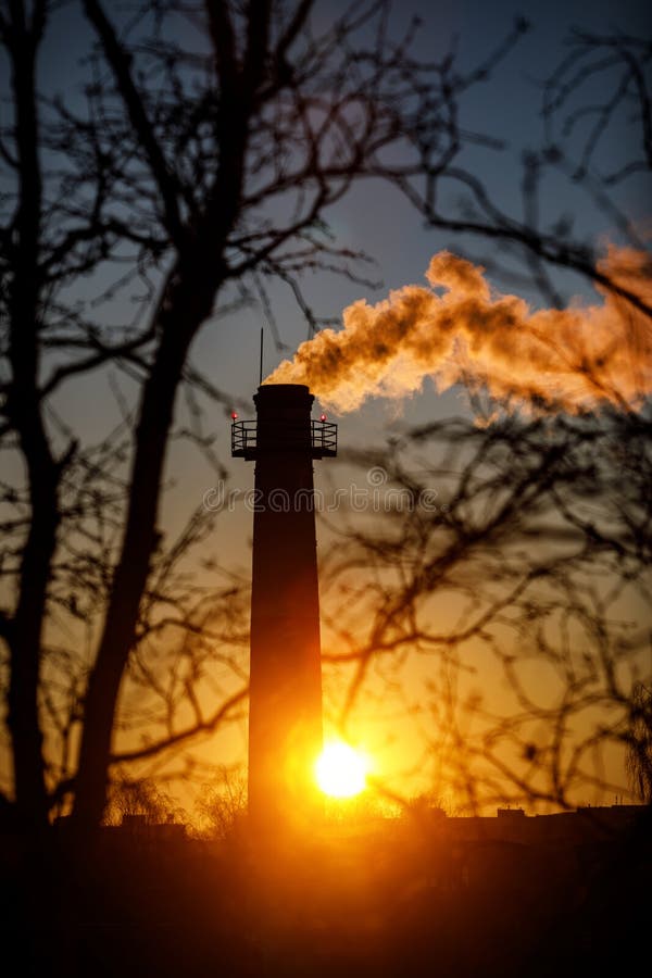 Factory Work, Chimney with Smoke, View through Tree Branches, Sunset ...