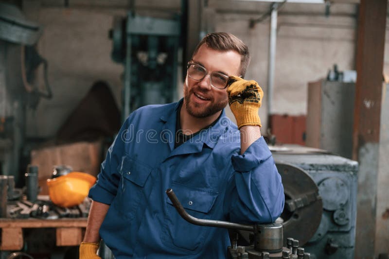 Factory Worker in Blue Uniform is Indoors Stock Photo - Image of ...