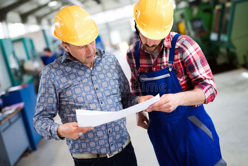 Factory Worker Discussing Data with Supervisor in Metal Factory Stock ...