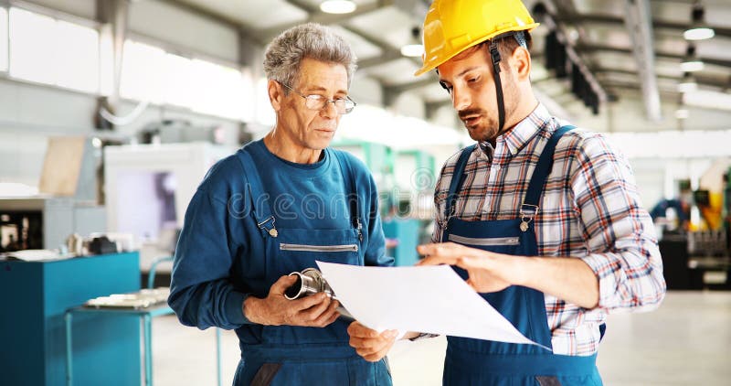 Factory Worker Discussing Data with Supervisor in Metal Factory Stock ...
