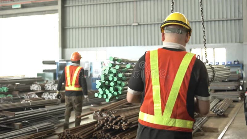 Factory Worker Helping in Lifting Steel Bars Stock Footage - Video of ...