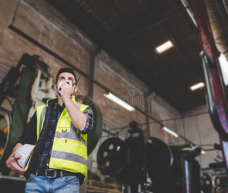 A Factory Worker Holds a Hard Hat and Talks a Radio Stock Photo - Image ...
