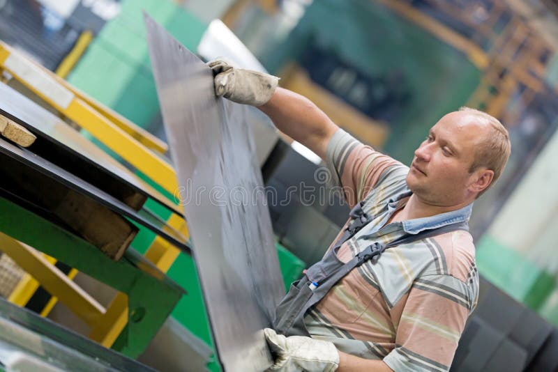 Factory Worker Moving Metal Sheet in Workshop Stock Photo - Image of ...