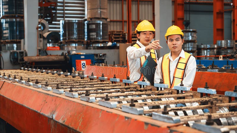 Factory Worker Operating Metal Stamping Machine with Engineer ...