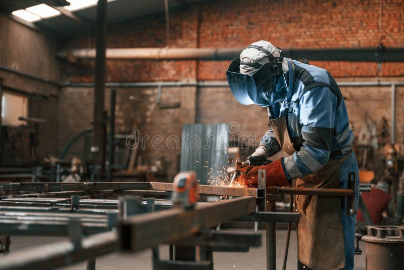 Factory Worker in Protective Mask is Welding the Iron Stock Photo ...