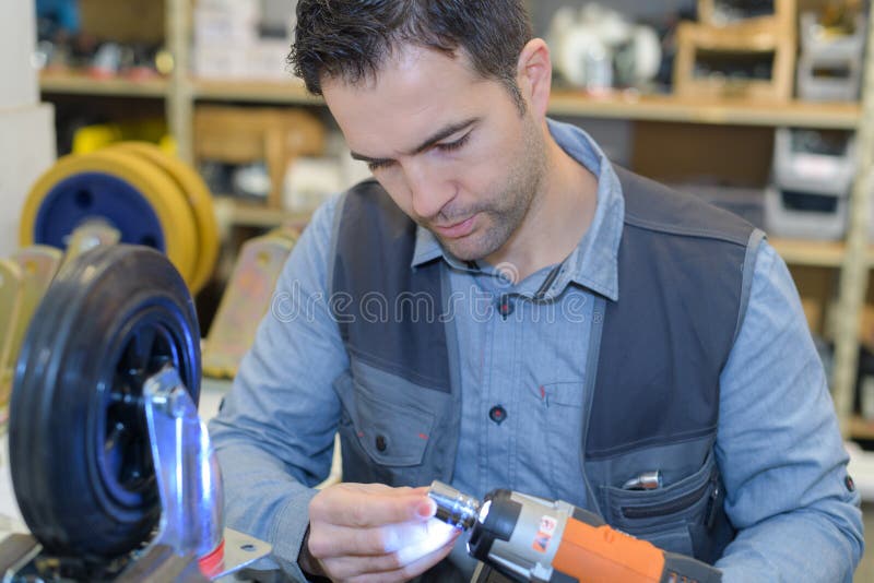 Testing New Wheel. Mechanic Holding a Tire at the Repair Garage Stock ...