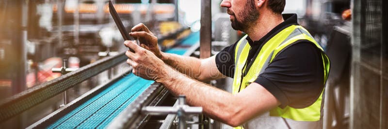 Factory Worker Using a Digital Tablet in Factory Stock Image - Image of ...