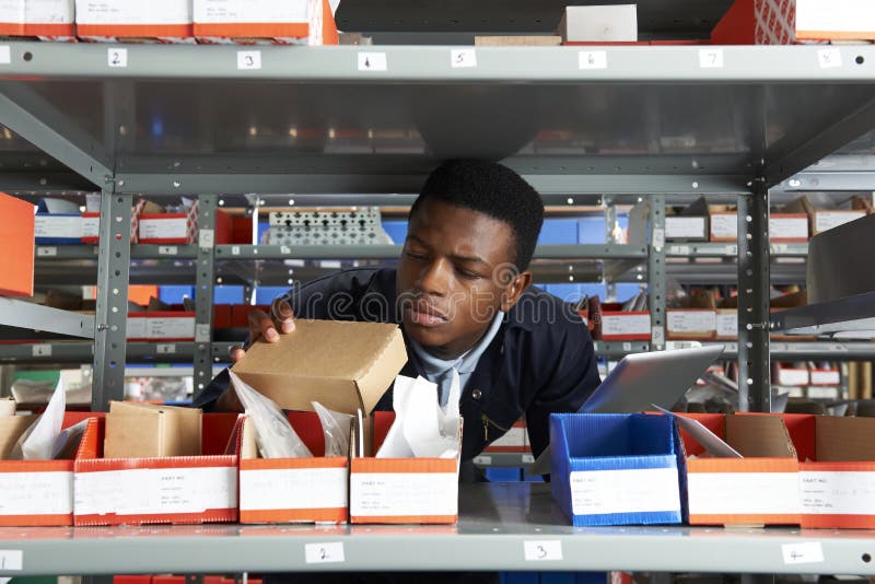 Factory Worker Using Digital Tablet in Store Room Stock Photo - Image ...