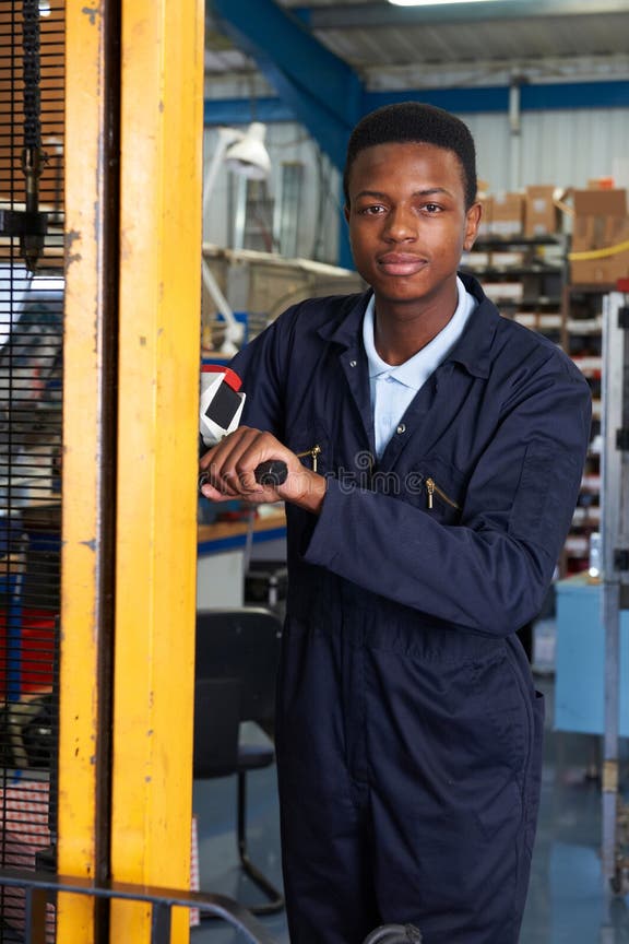 Factory Worker Using Powered Fork Lift To Load Goods Stock Image ...