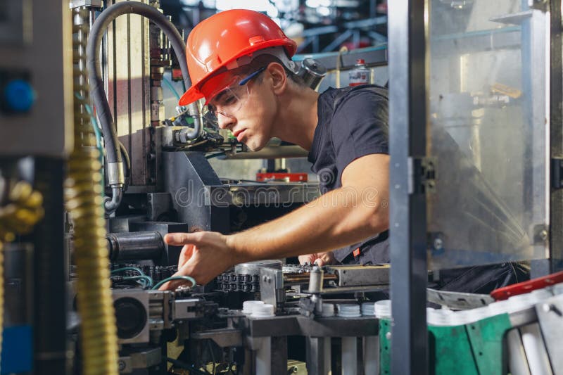 Factory Worker Working in Industrial Building Indoor. Man Fixing ...