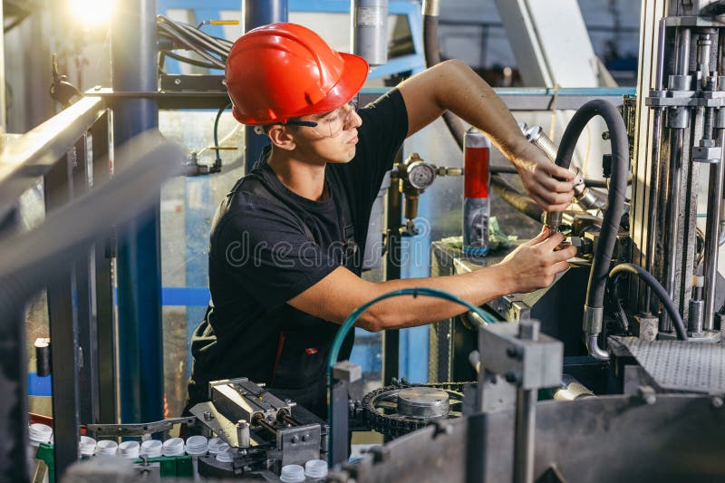 Factory Worker Working in Industrial Building Indoor. Man Fixing ...