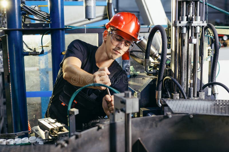 Factory Worker Working in Industrial Building Indoor. Man Fixing ...