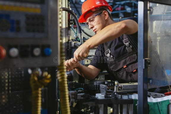 Factory Worker Working in Industrial Building Indoor. Man Fixing ...