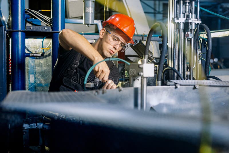 Factory Worker Working in Industrial Building Indoor. Man Fixing ...