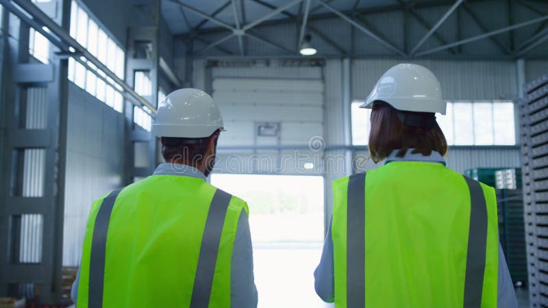 Factory Workers Back View Walking in Warehouse Discussing Storage ...