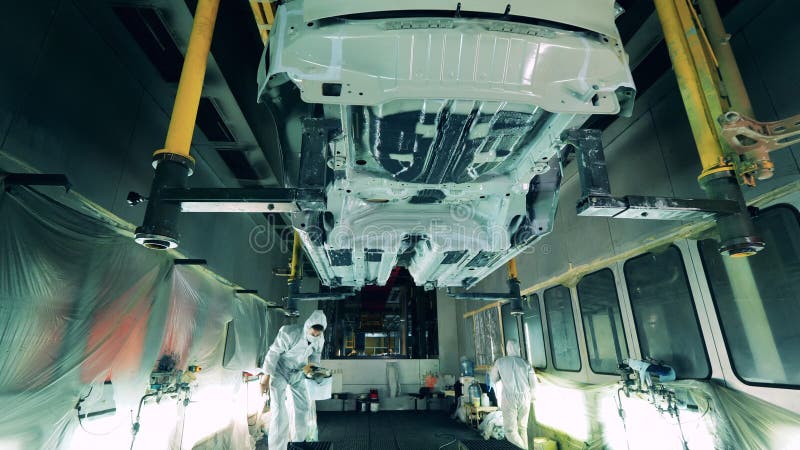 Car Factory Workers Using Modern Welding Machines To Weld Car Parts ...