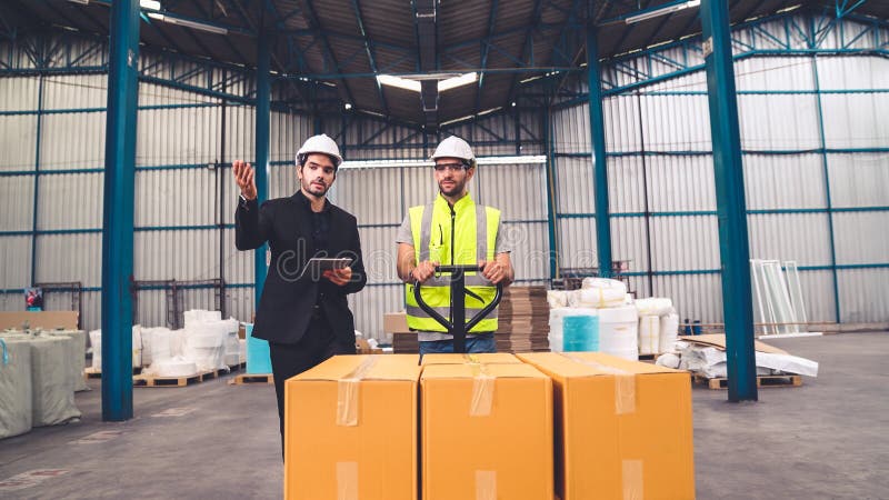 Factory Workers Deliver Boxes Package on a Pushing Trolley in the ...
