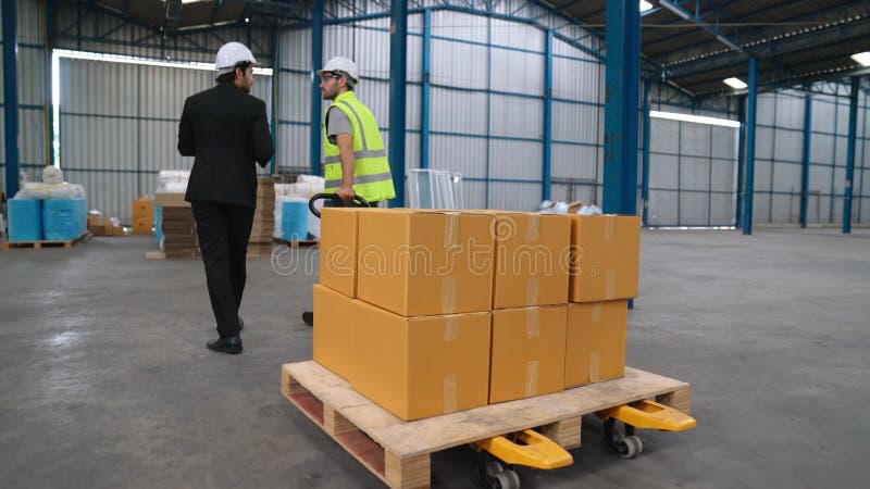 Factory Workers Deliver Boxes Package on a Pushing Trolley in the ...