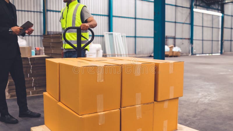 Factory Workers Deliver Boxes Package on a Pushing Trolley in the ...