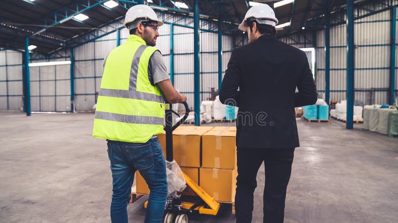 Factory Workers Deliver Boxes Package on a Pushing Trolley in the ...