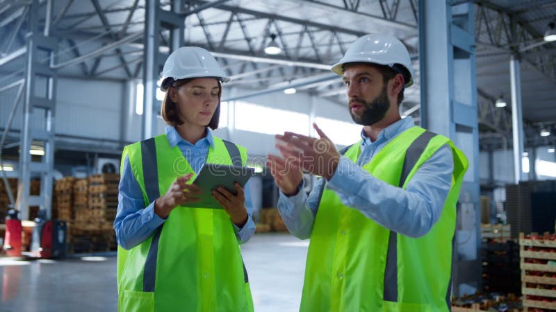 Factory Workers Discussing Tablet Information Analysing Production ...
