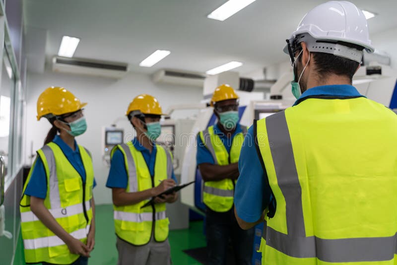 Factory Workers Meeting before Work and Put on a Mask. Stock Image ...