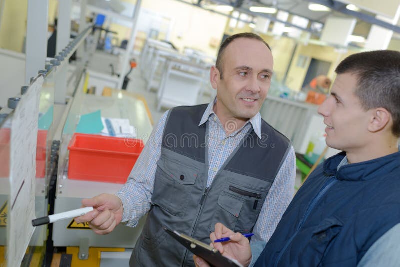 Factory Workers Reviewing Planning Stock Image - Image of explain, plan ...