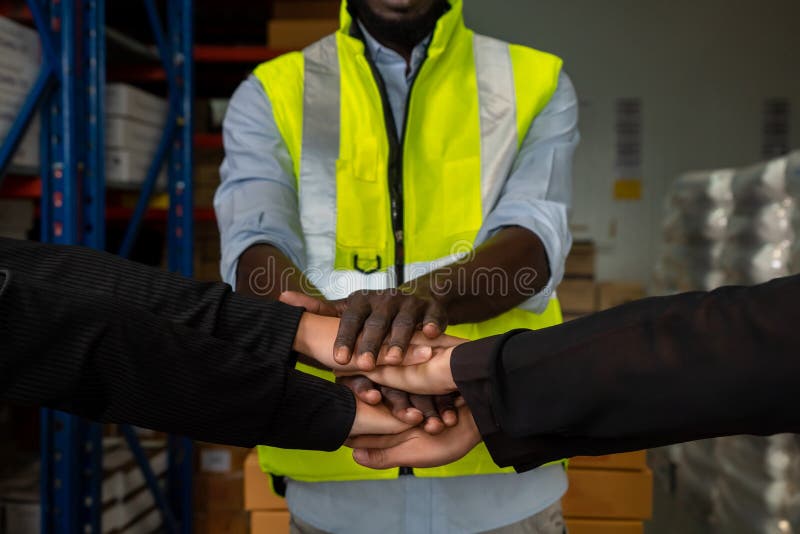 Factory Workers Stacking Hands Together in Warehouse or Storehouse ...