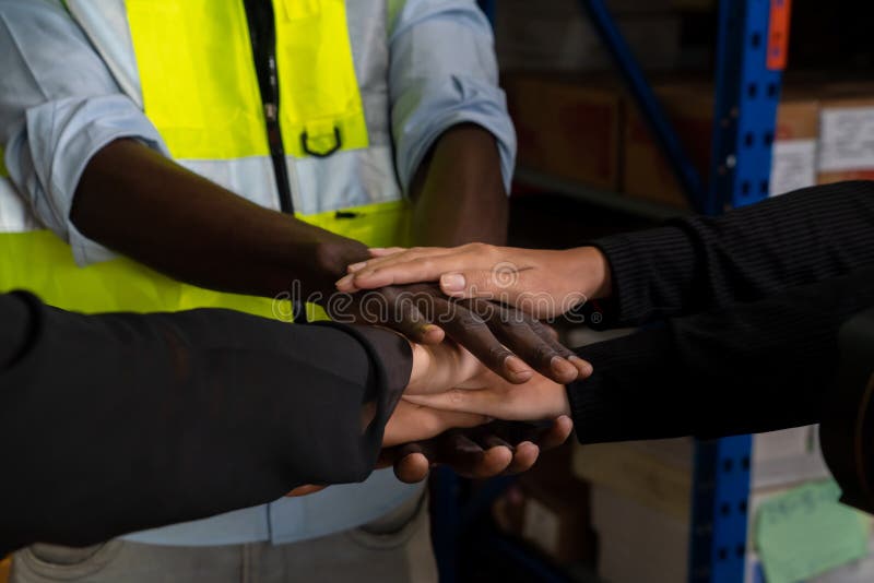Factory Workers Stacking Hands Together in Warehouse or Storehouse ...