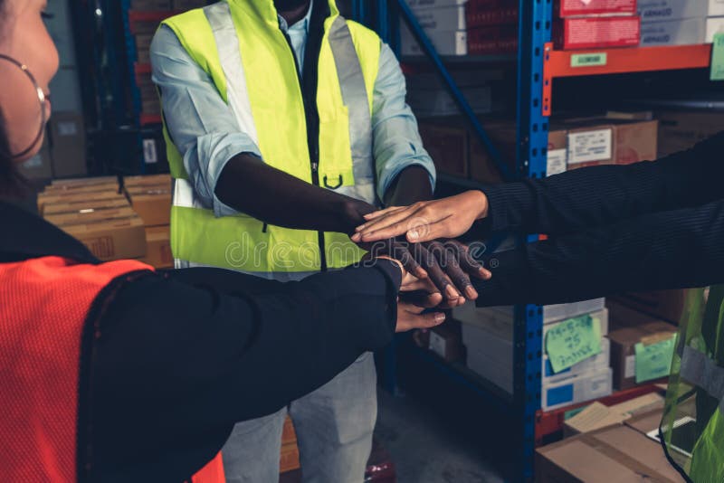 Factory Workers Stacking Hands Together in Warehouse or Storehouse ...