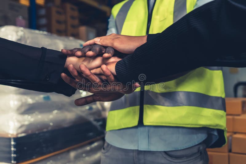 Factory Workers Stacking Hands Together in Warehouse or Storehouse ...