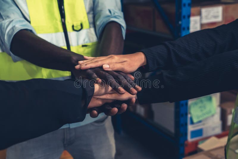 Factory Workers Stacking Hands Together in Warehouse or Storehouse ...