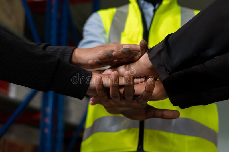 Factory Workers Stacking Hands Together in Warehouse or Storehouse ...