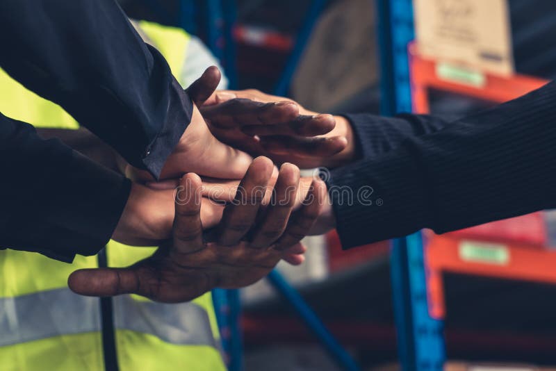 Factory Workers Stacking Hands Together in Warehouse or Storehouse ...