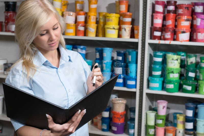Factory Working Writing in Folder in Front of Shelves Stock Image ...