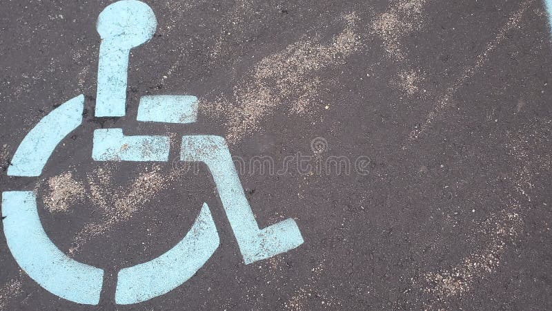 Faded Handicap Symbol on Dark Pavement Stock Photo - Image of ...
