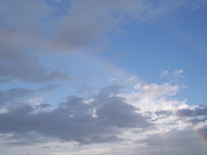 Faint Double Rainbow Against Blue Sky and Clouds Stock Photo - Image of ...
