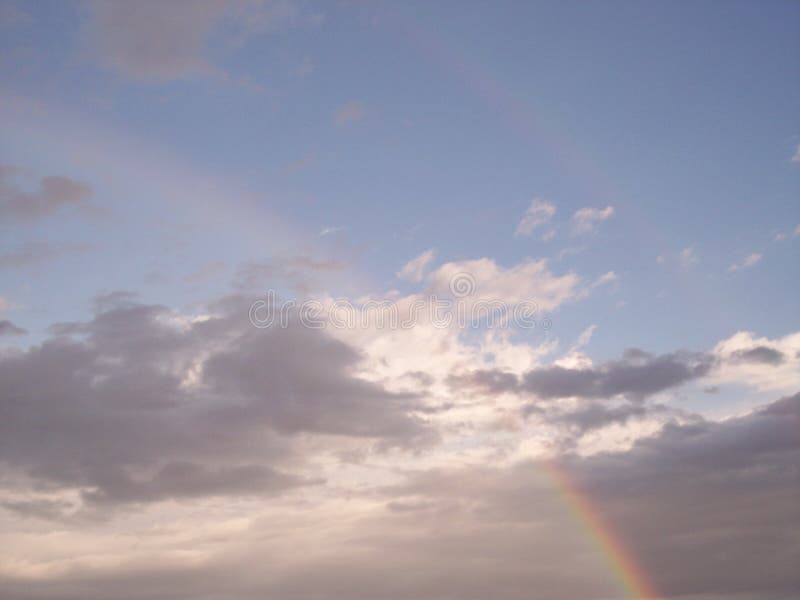 Faint Double Rainbow Against Blue Sky and Clouds Stock Photo - Image of ...