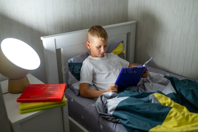 Fair-haired Teenage Boy Reading Book before Bed Stock Photo - Image of ...